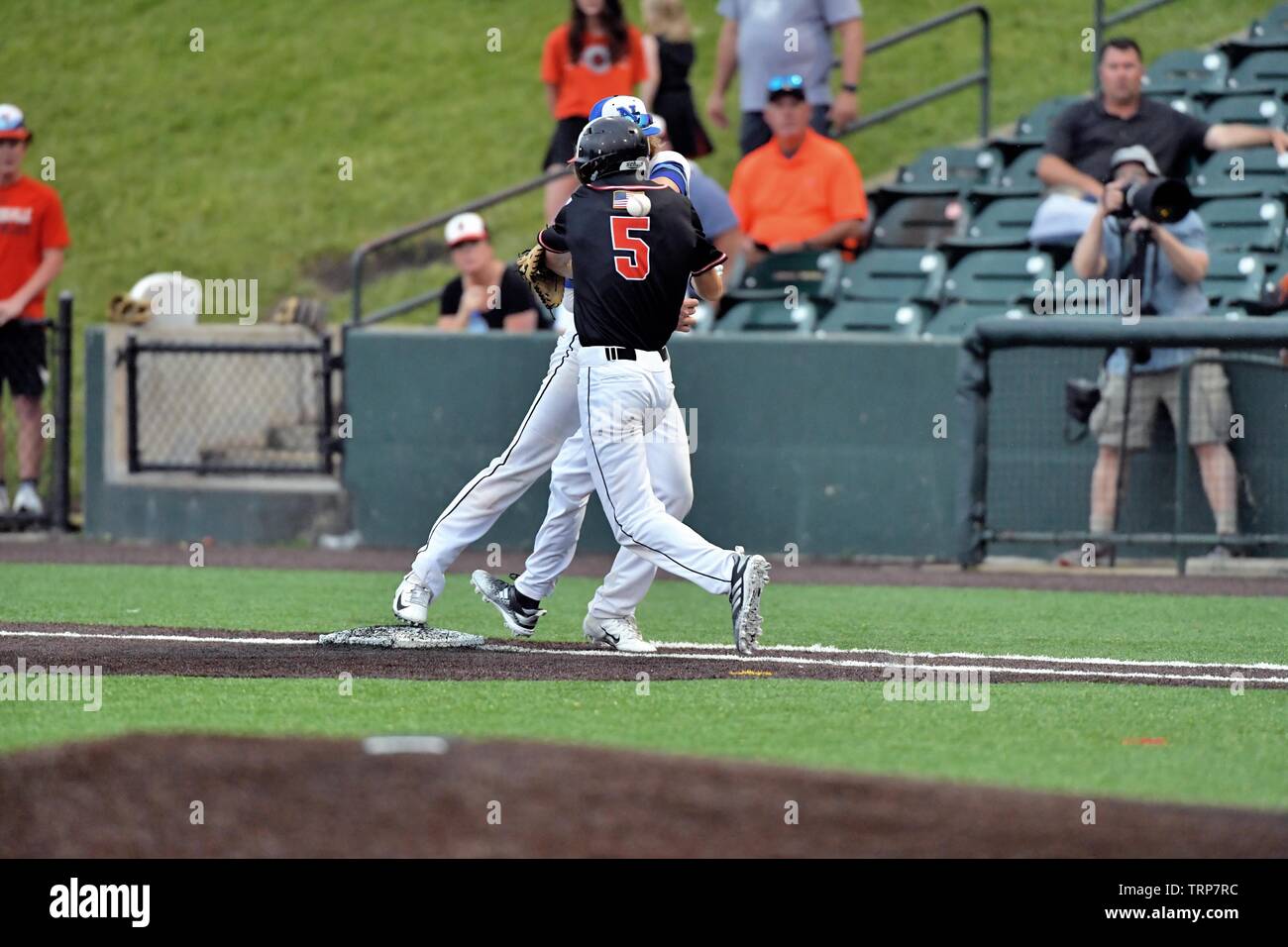 On the outside of the foul line, a first baseman was unable to secure a ...