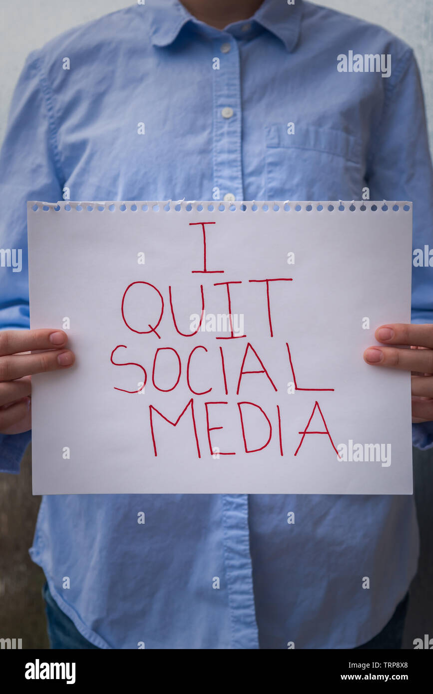 Person holding sign that says I Quit Social Media, illustrating the ...