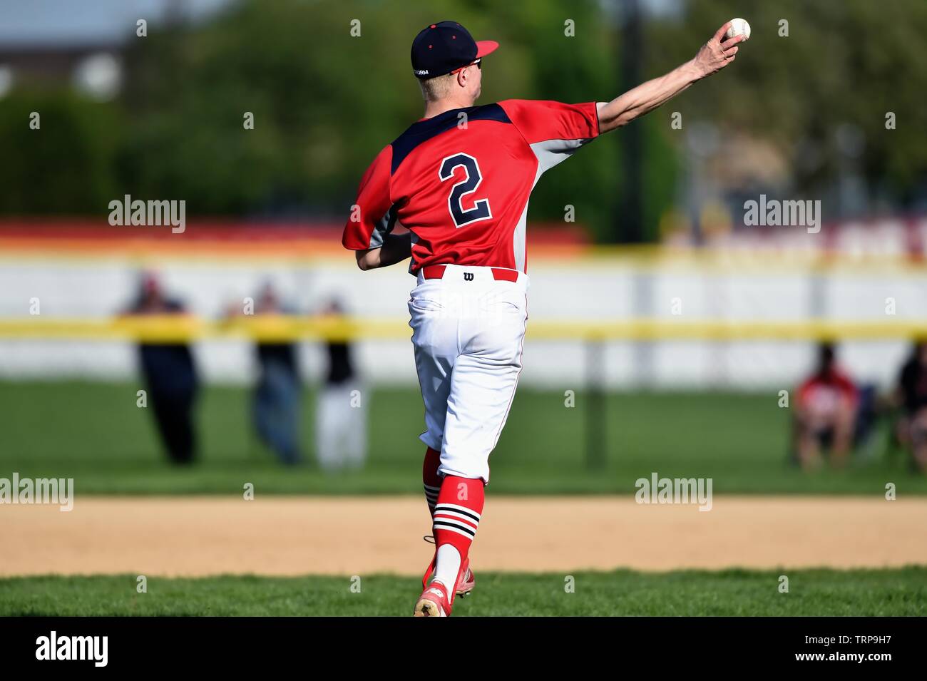 Shortstop, after fielding a slowly hit ground ball throwing on to first ...