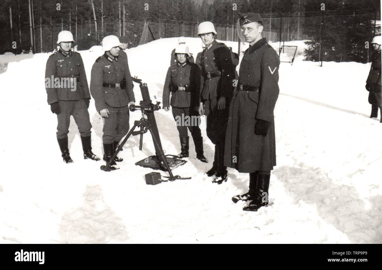 German Soldiers in winter coats with Whitewashed helmets train on a ...