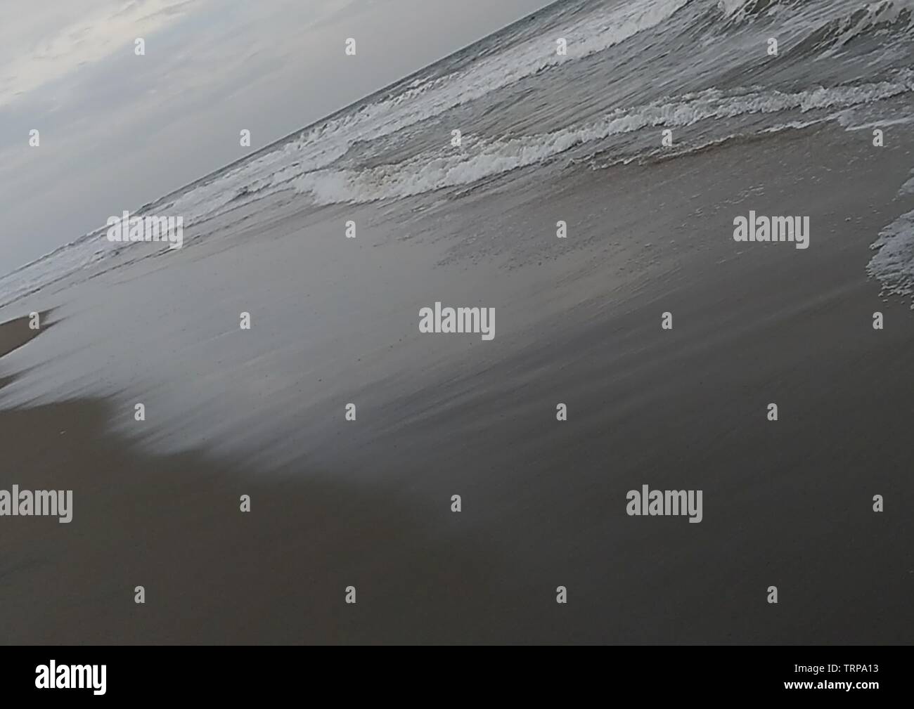 beach with fading water texture Stock Photo - Alamy