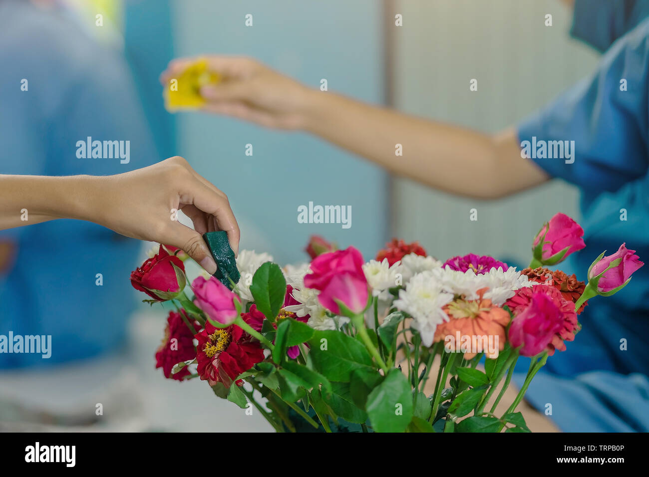 Students help each other to create a flowers tray with pedestal for The ...