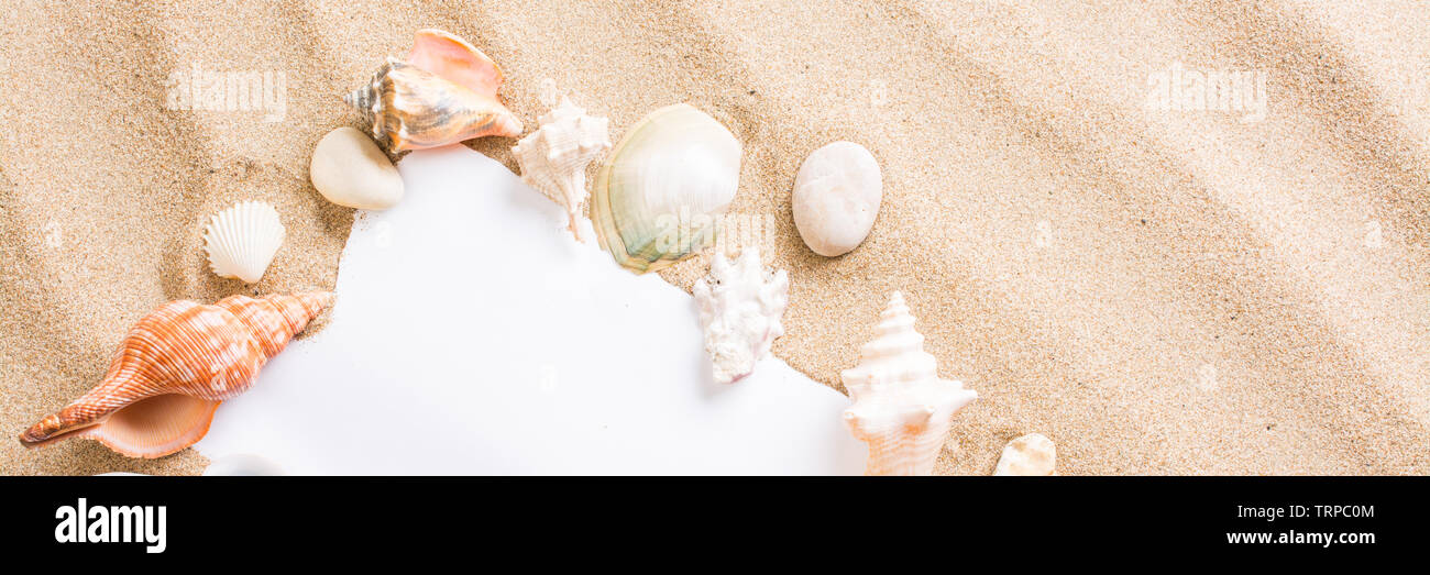 Message in torn paper on the beach. Summer background with hot sand ...