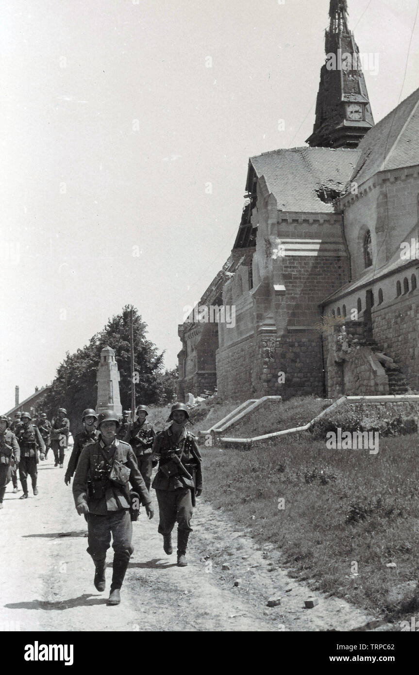 German Soldiers pass by a French Cathedral during the French Campaign ...