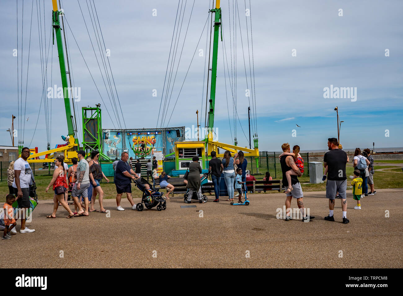 The “Sling Shot” fairground ride on the seafront of the coastal town of ...