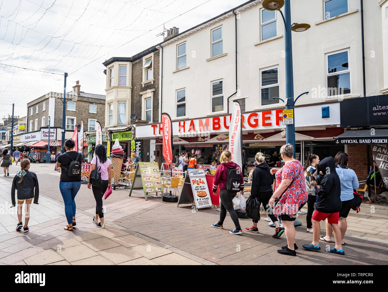 Tourists walking up Regent Road, a street full of restaurants, eateries ...