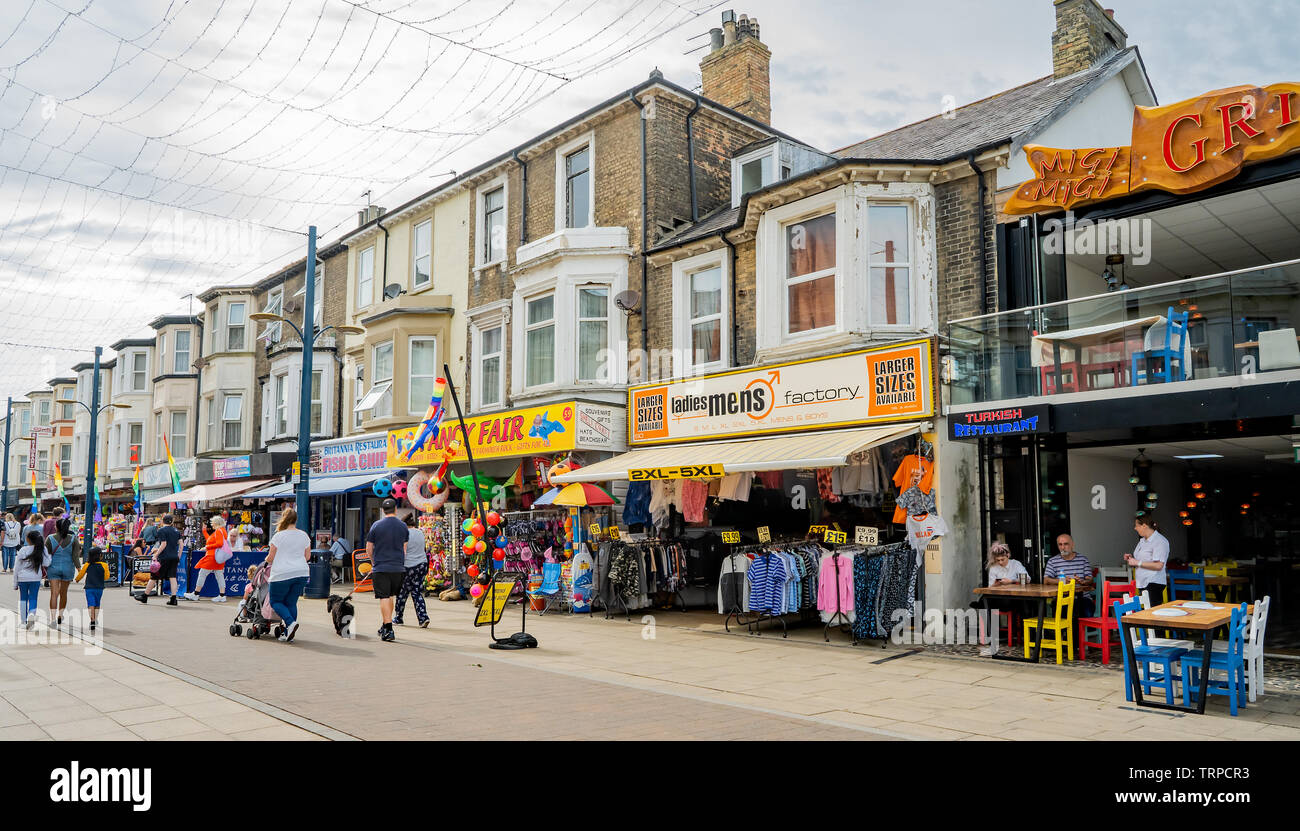 Tourists walking up Regent Road, a street full of restaurants, eateries ...