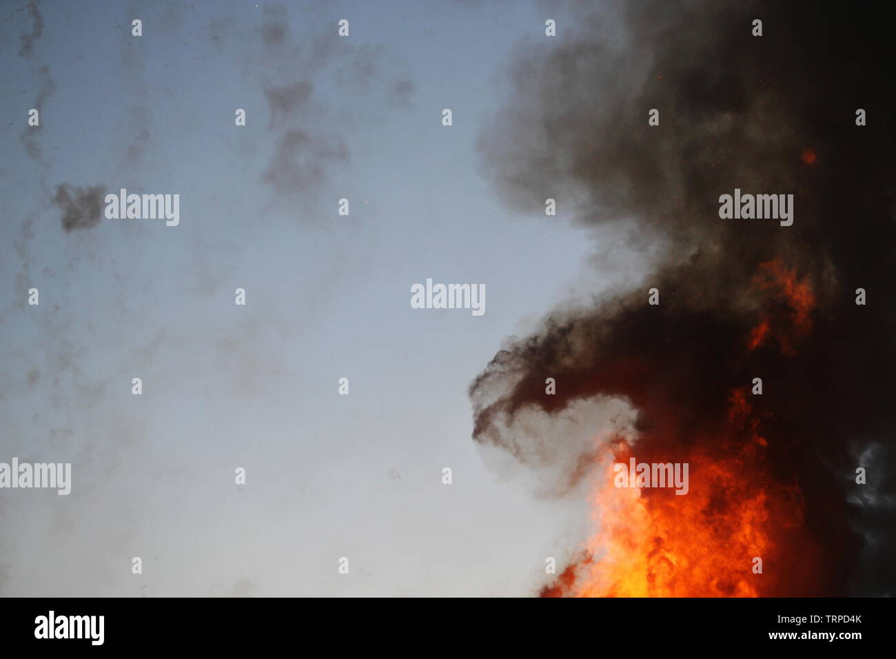 Flames and black smoke rising against the sky Stock Photo - Alamy