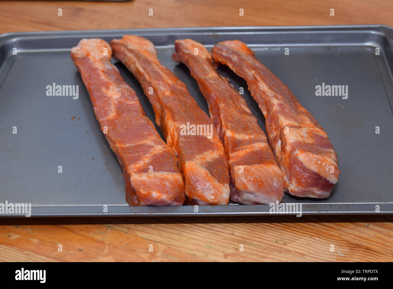 Rack of juicy marinated ribs on a flat silver baking tray Stock Photo ...