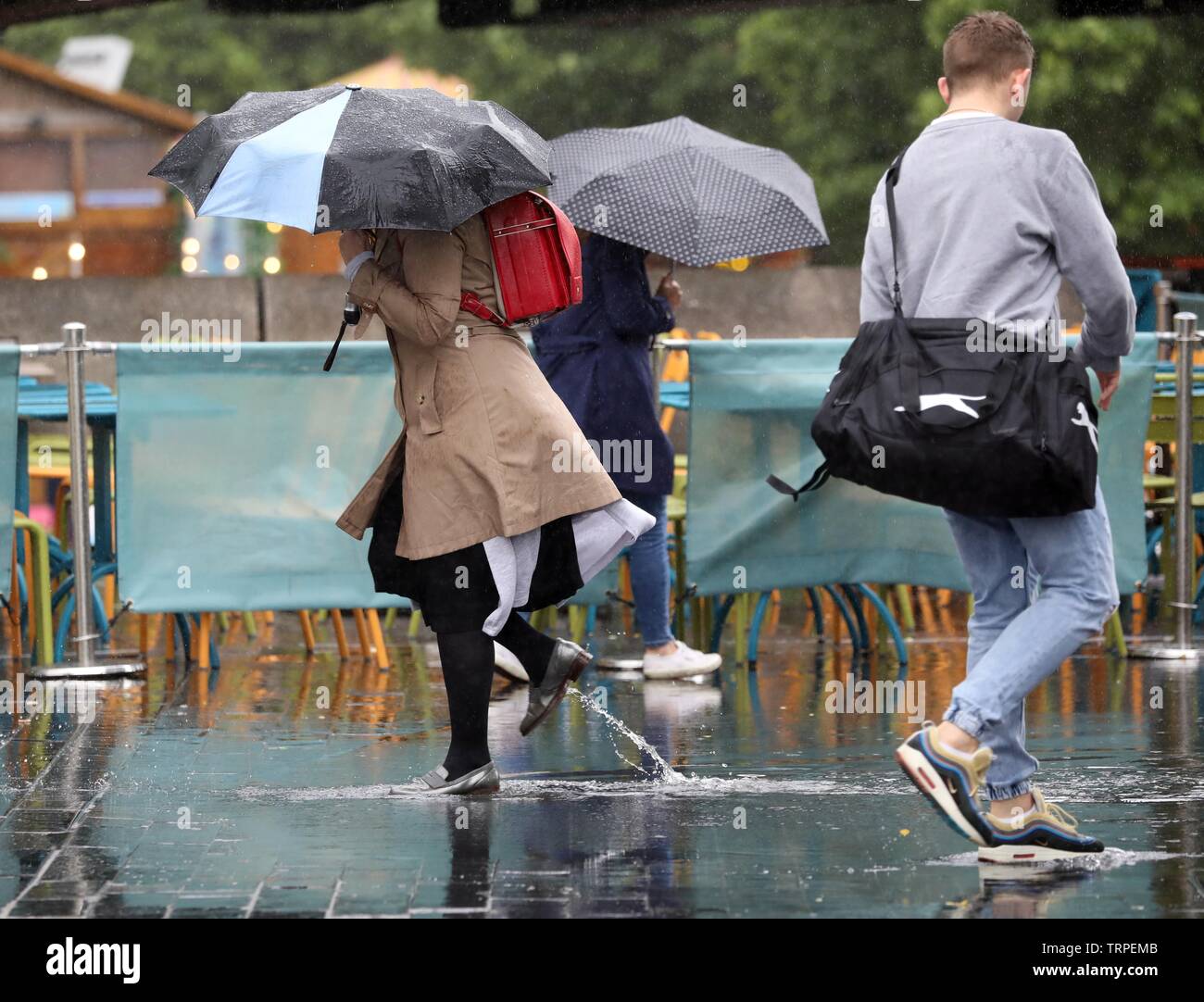 Pic shows: Wet weather Tramping through deep puddles of rain Monday 10. ...