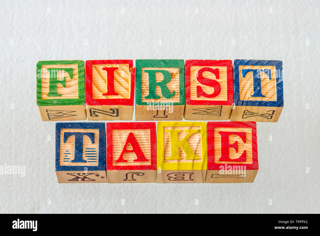 The term first take visually displayed using wooden blocks on a clear ...