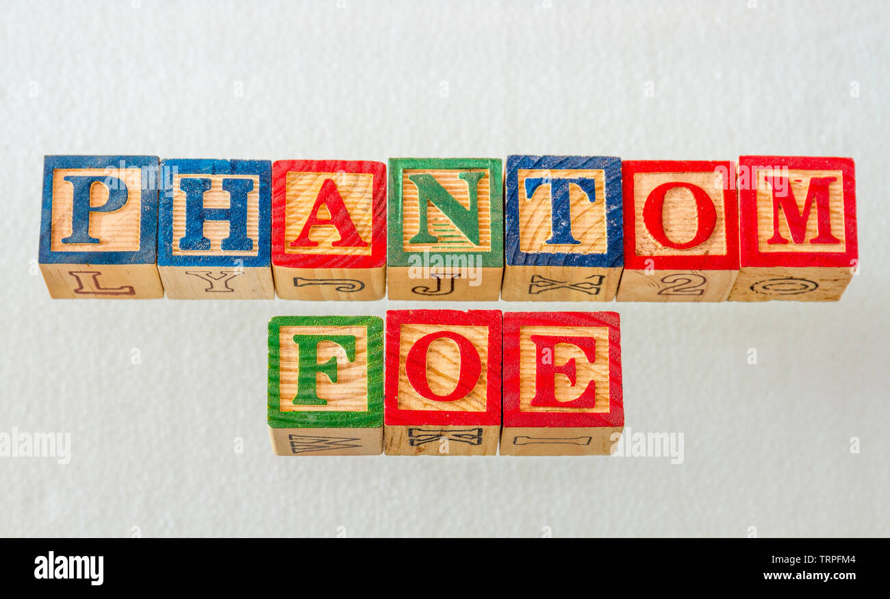 The term phantom foe visually displayed using wooden blocks on a clear ...
