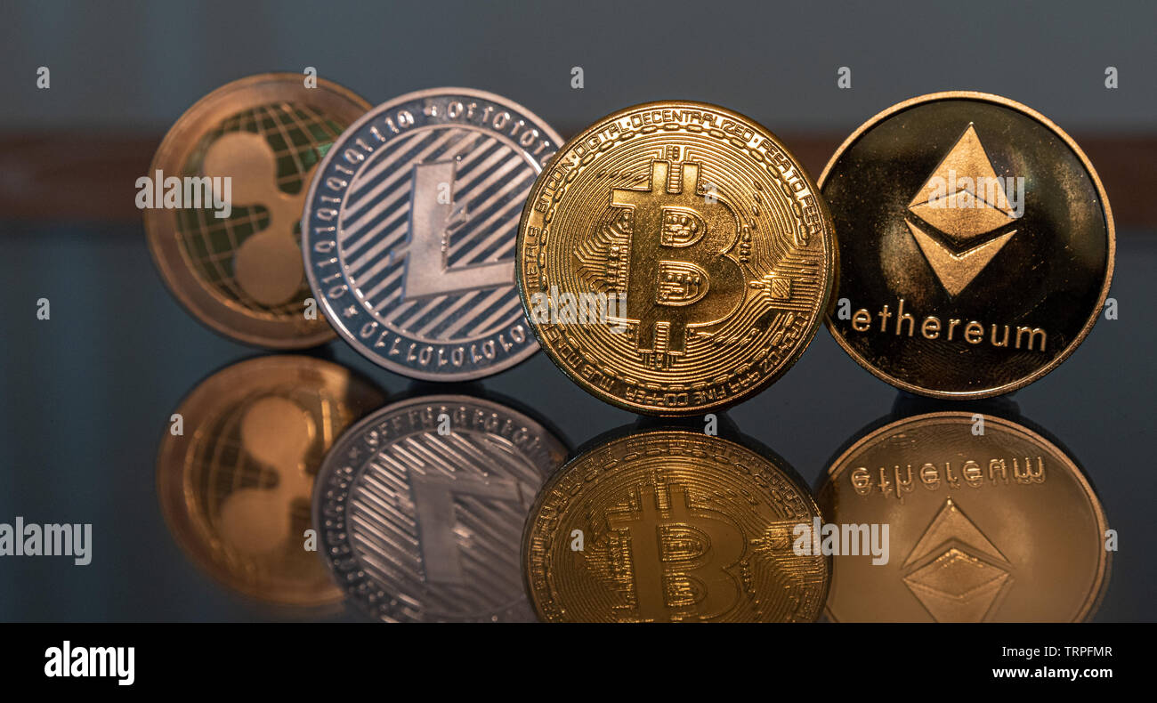bitcoin lite coin ethereum ripple coin in a line on a mirror Stock ...
