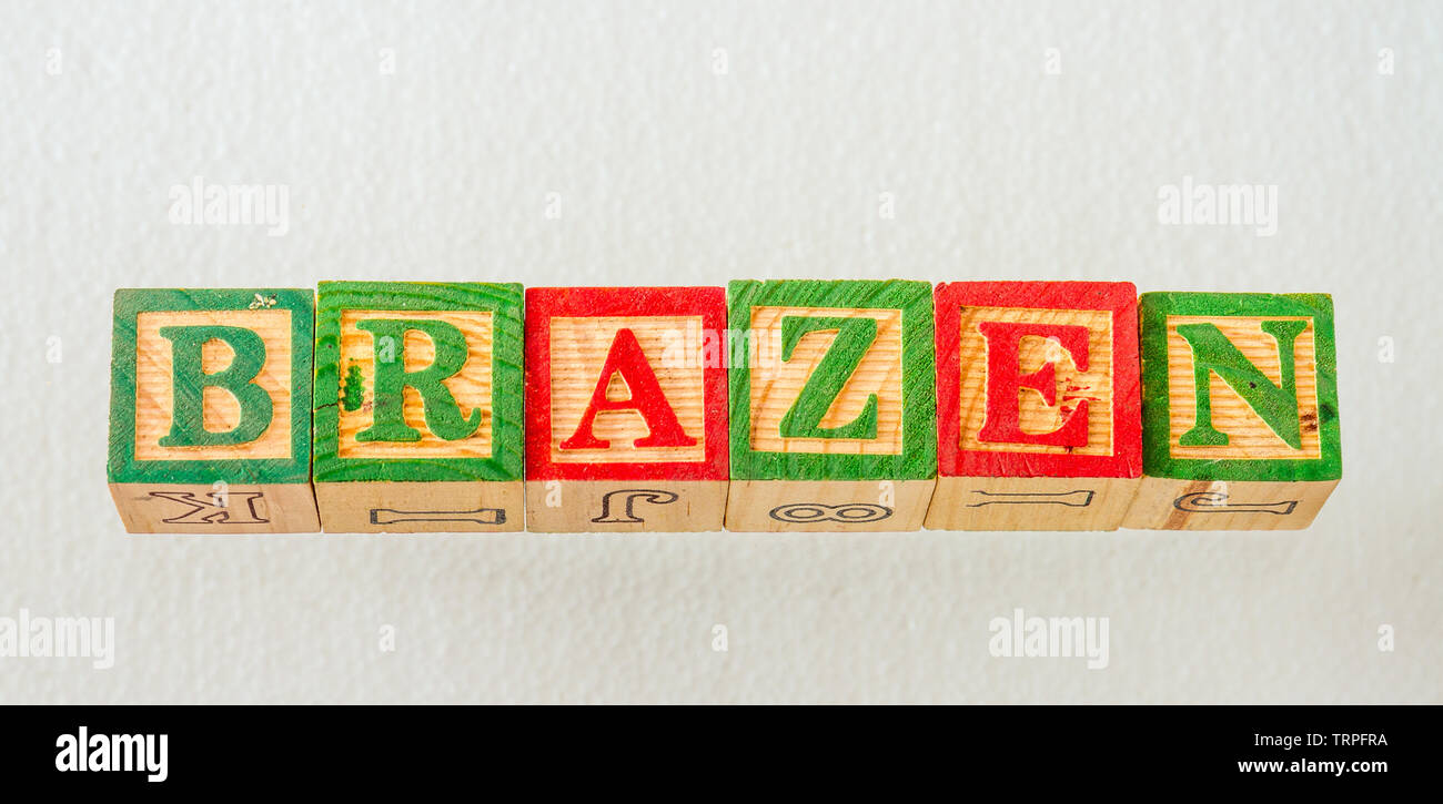 The term brazen visually displayed using wooden blocks on a clear ...