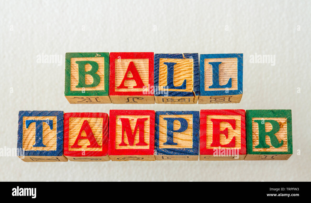 The term ball tamper visually displayed using wooden blocks on a clear ...