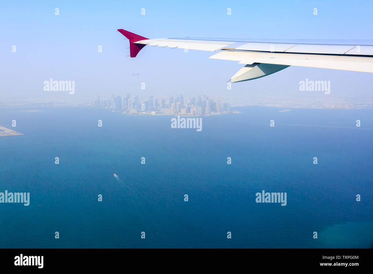 View of the city of Doha, Qatar from the airplane porthole. Plane flies ...