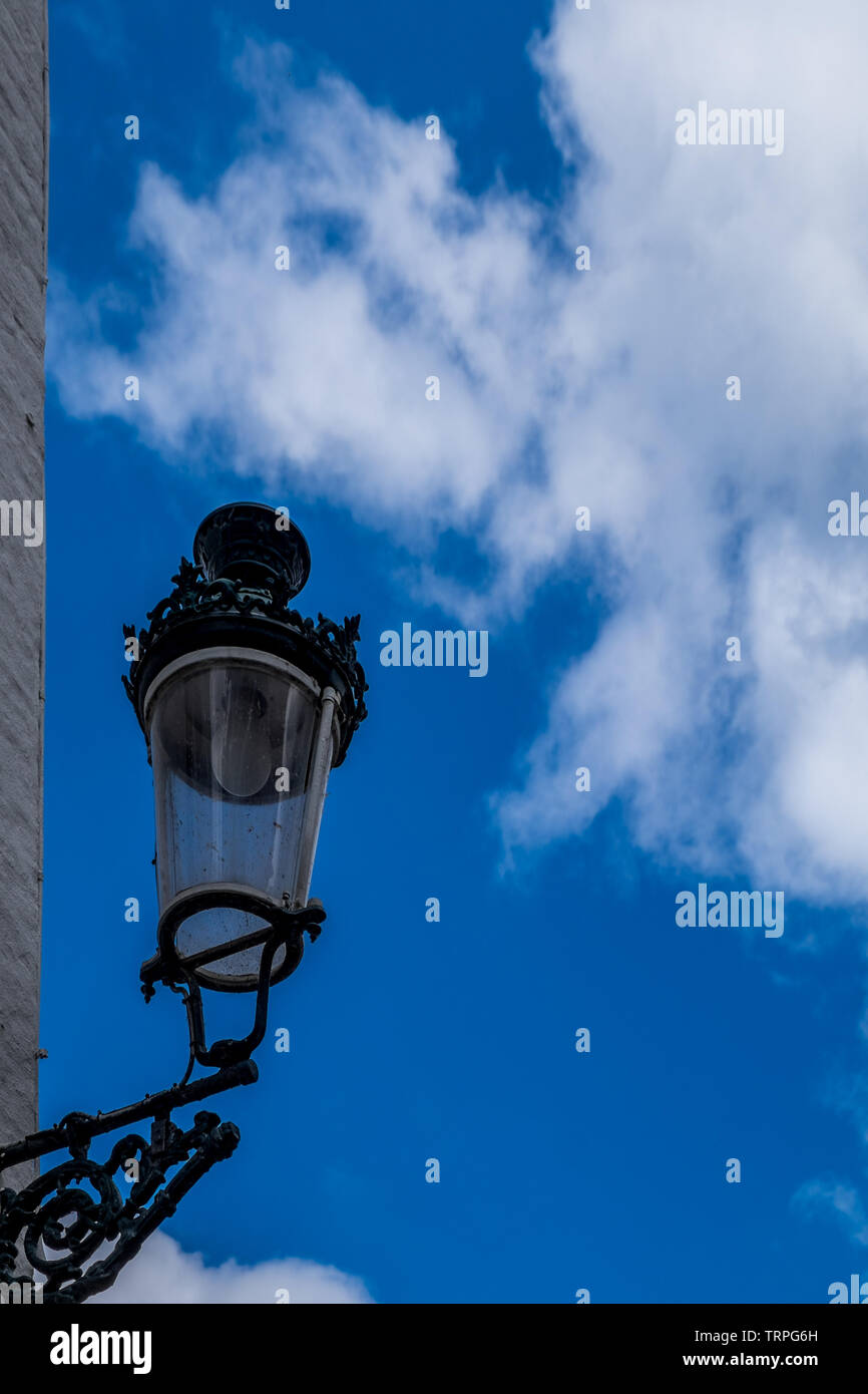 Outside wall light on side of a building with the sky as backgound ...