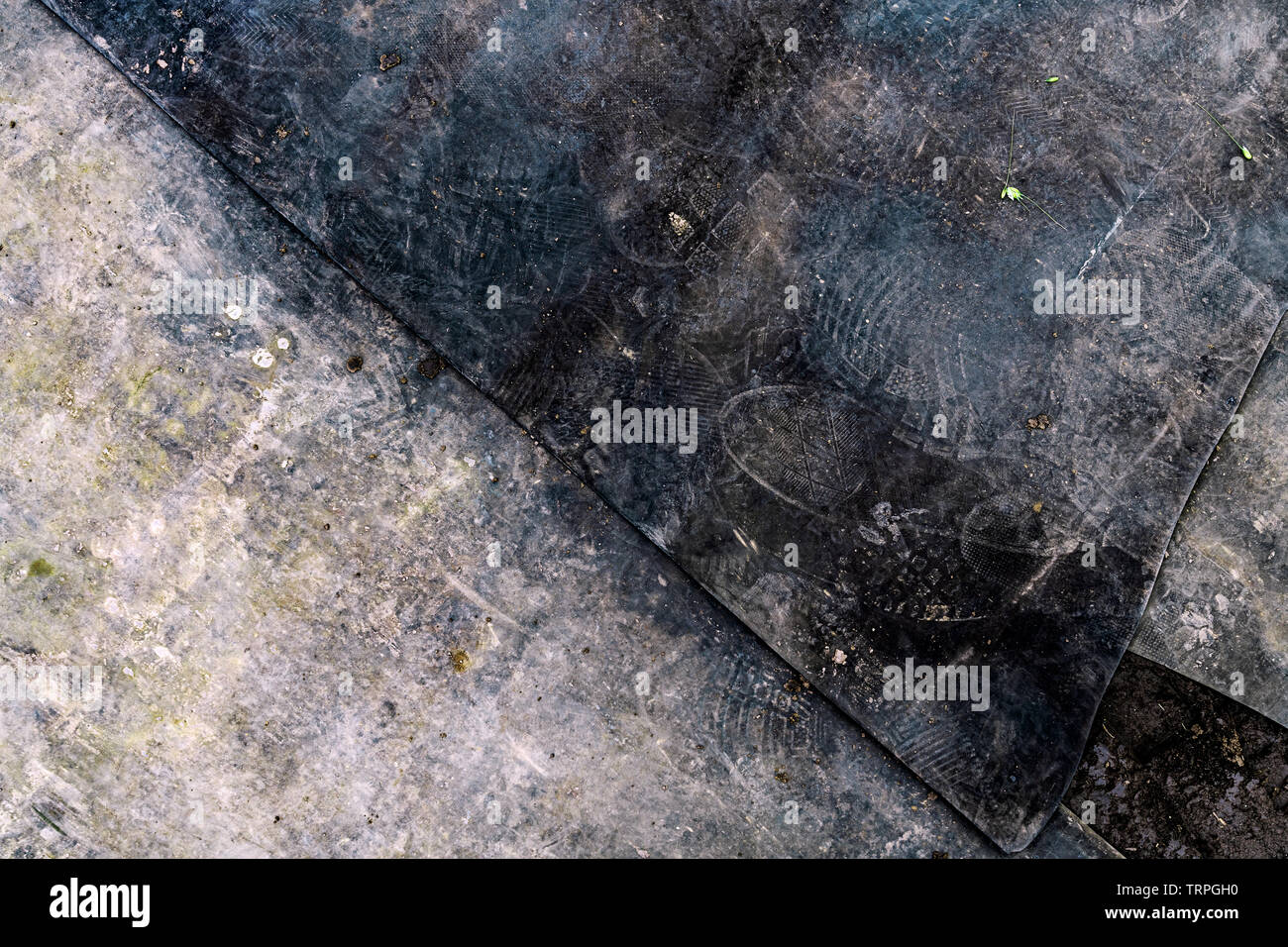 Dark grunge background with footprints and dirt particles, top view ...