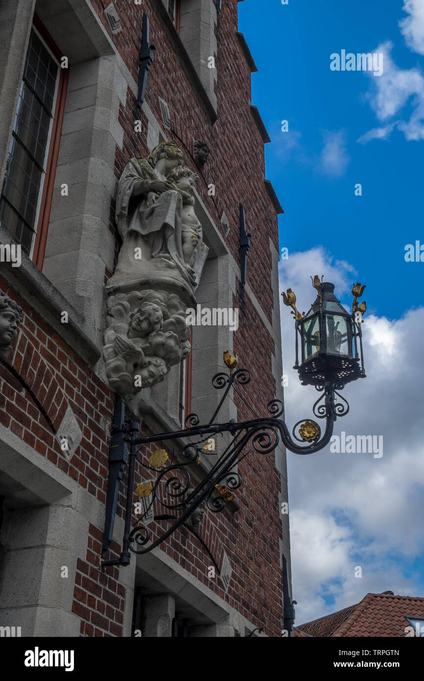Outside wall light on side of a building with the sky as backgound ...