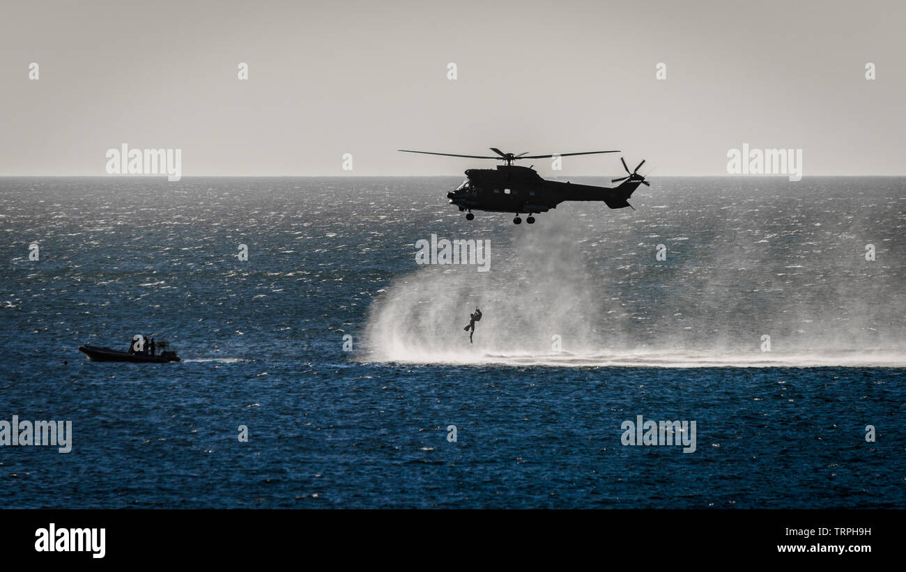 South African Airforce Oryx helicopter hoists a man from the False Bay ...