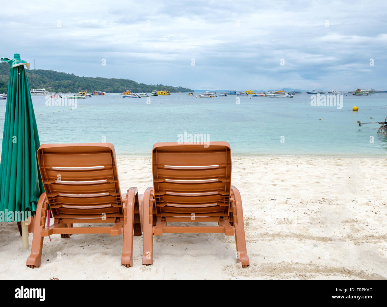 Two beach chairs on white sand at phi phi island Stock Photo - Alamy
