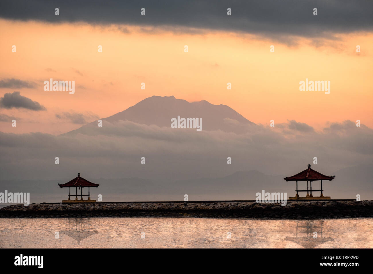 Mount volcano (Agung) with two pavilion on jetty at Sanur beach, Bali ...