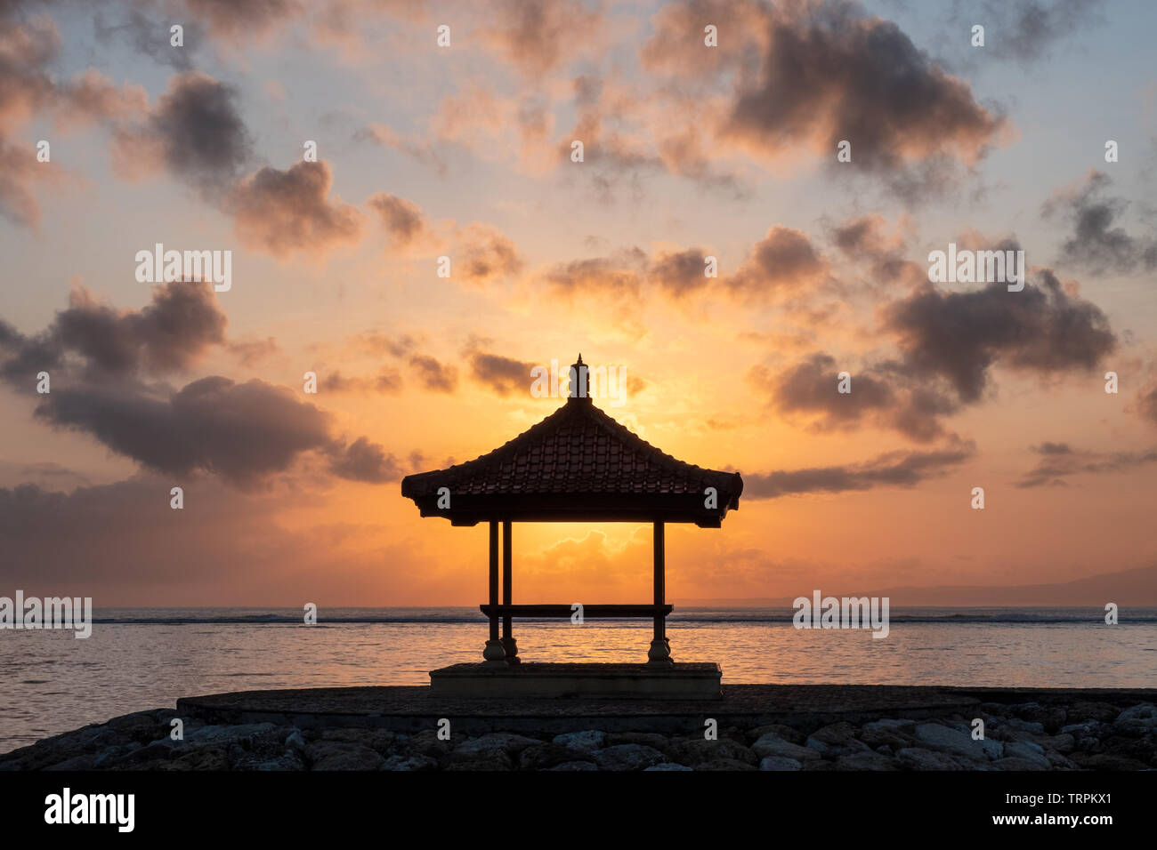 Sunshine in pavilion on jetty at coastline in morning. Sanur beach ...