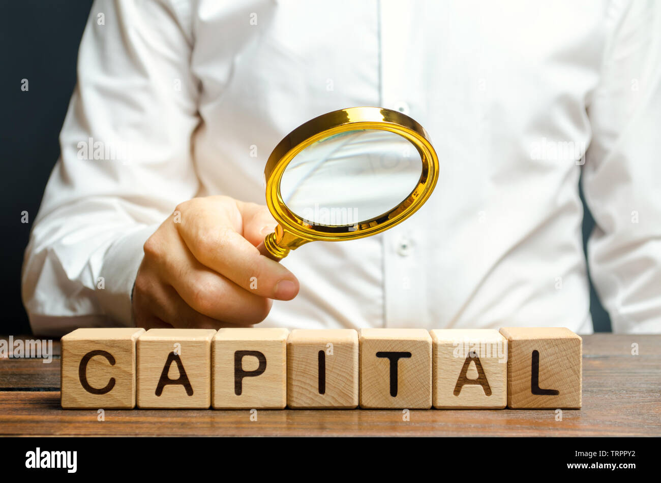 Businessman exploring the origin of capital. The combination of ...