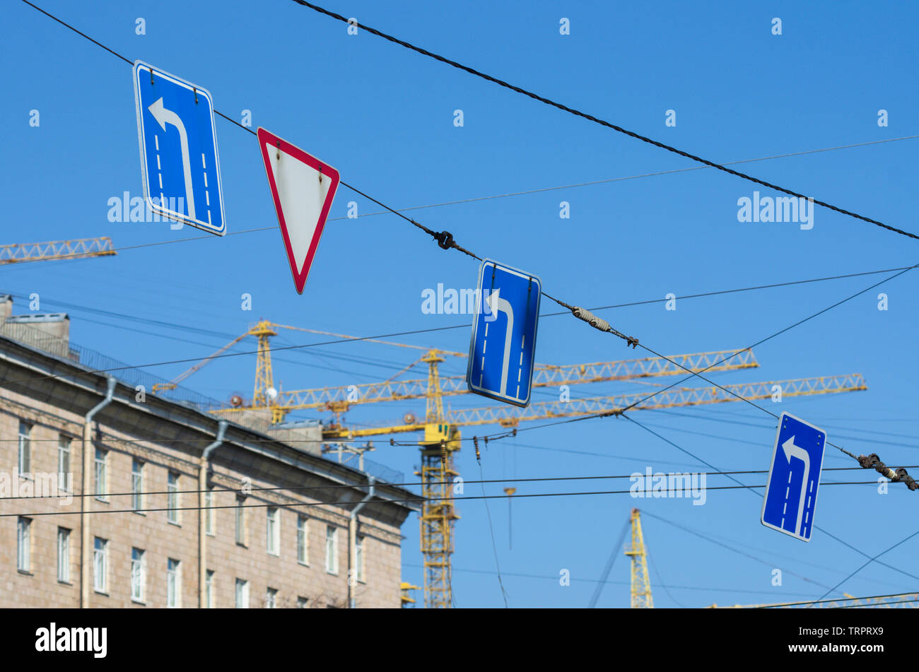 Road signs "turn left" and "give way" in the background construction ...
