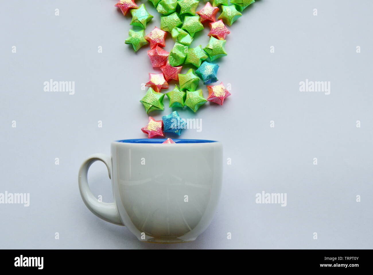 colorful star paper splashing from coffee cup on white background Stock ...