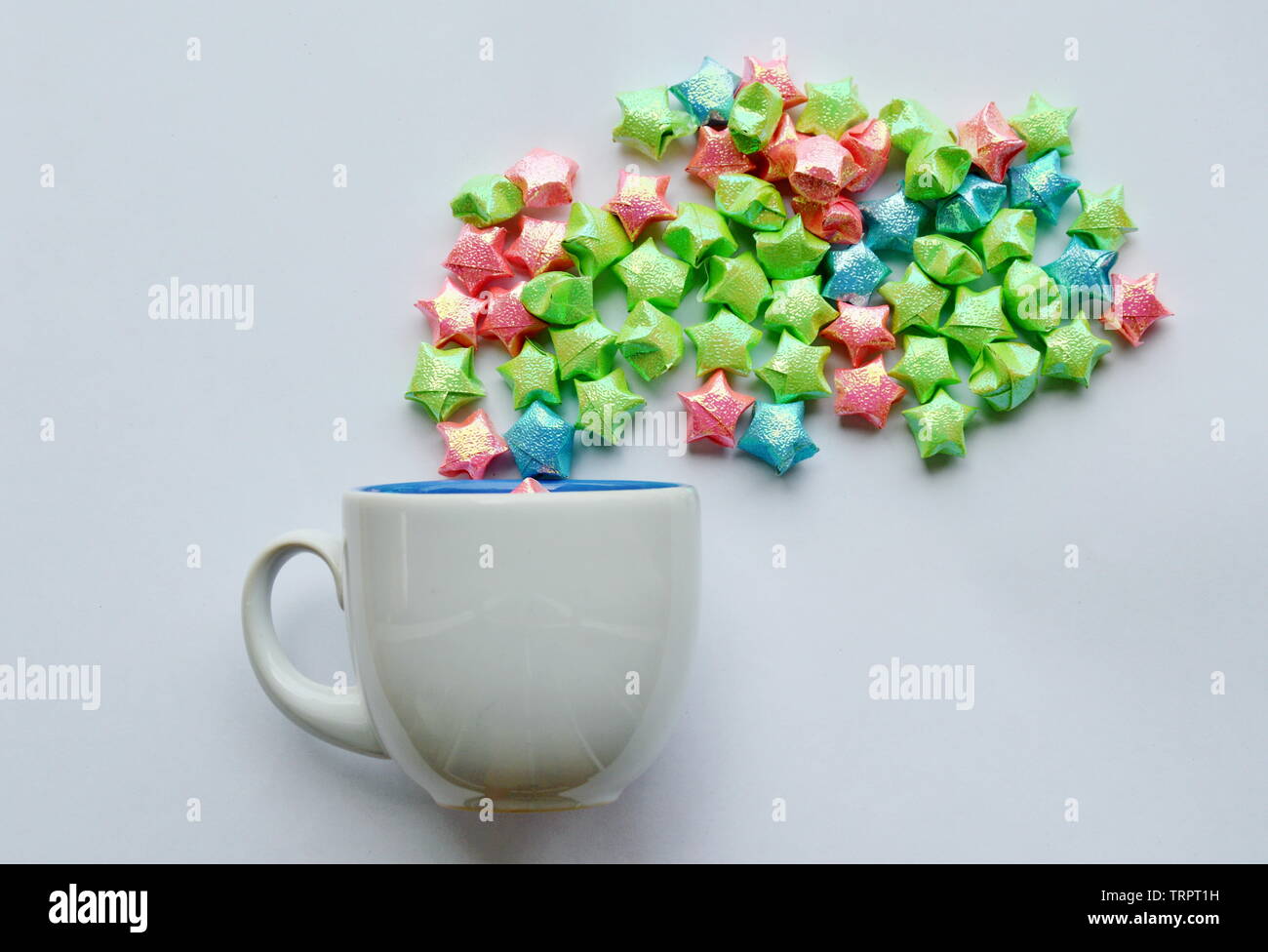 colorful star paper splashing from coffee cup on white background Stock ...