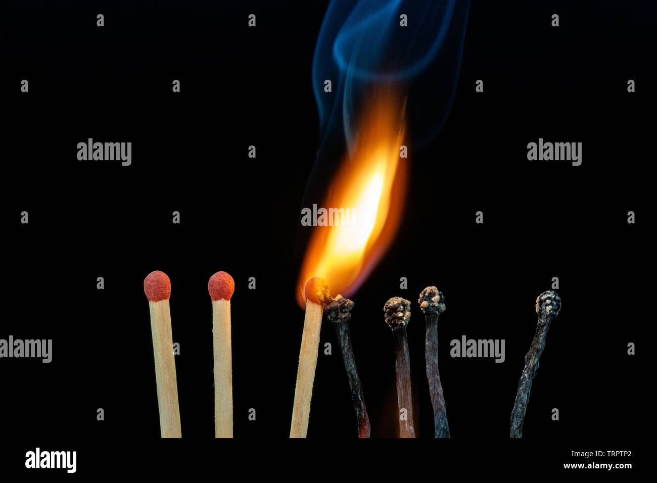Line of burning matches on dark background Stock Photo - Alamy