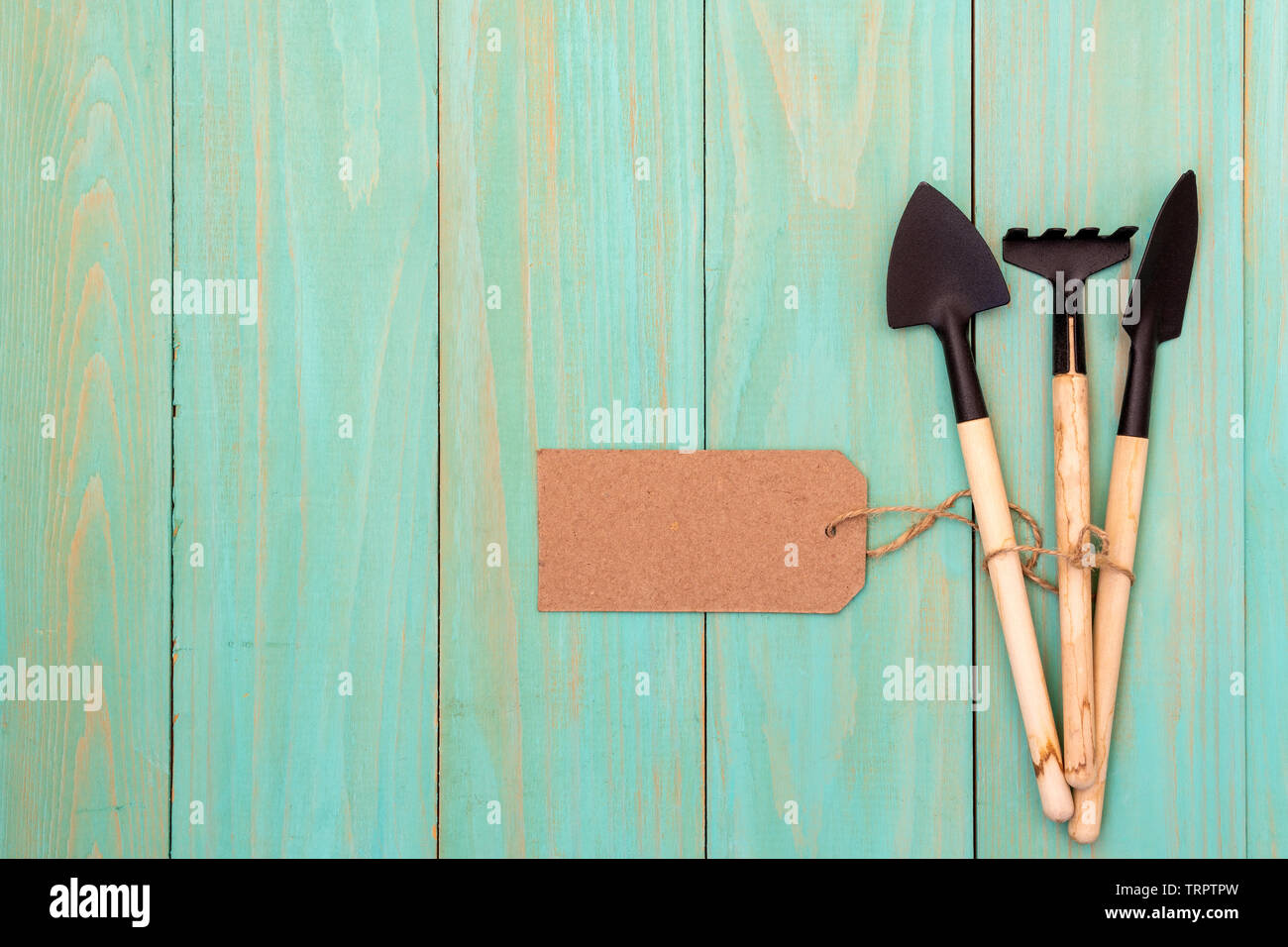 Gardening tools with blank tag on wood background Stock Photo - Alamy