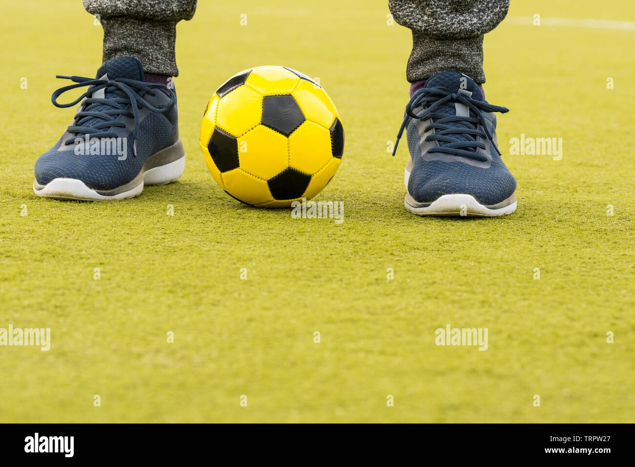 Feet of player with ball on artificial turf soccer field Stock Photo ...