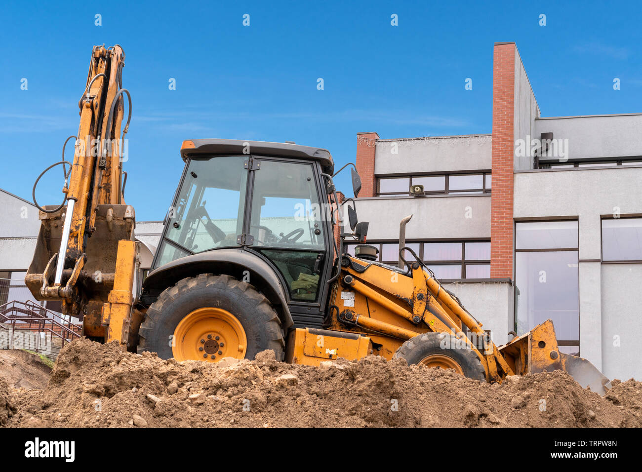 Yellow loader excavator works in construction site Stock Photo - Alamy