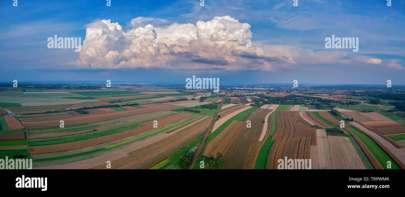 Aerial panorama of fields under blue sky and big white cloud Stock ...