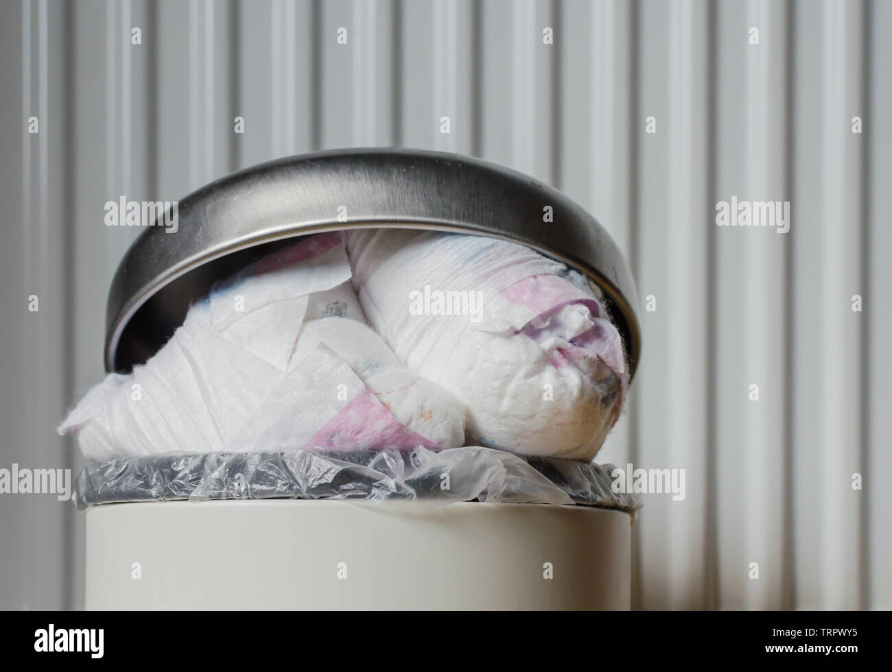 Trash bin full of used diapers. Close up Stock Photo - Alamy