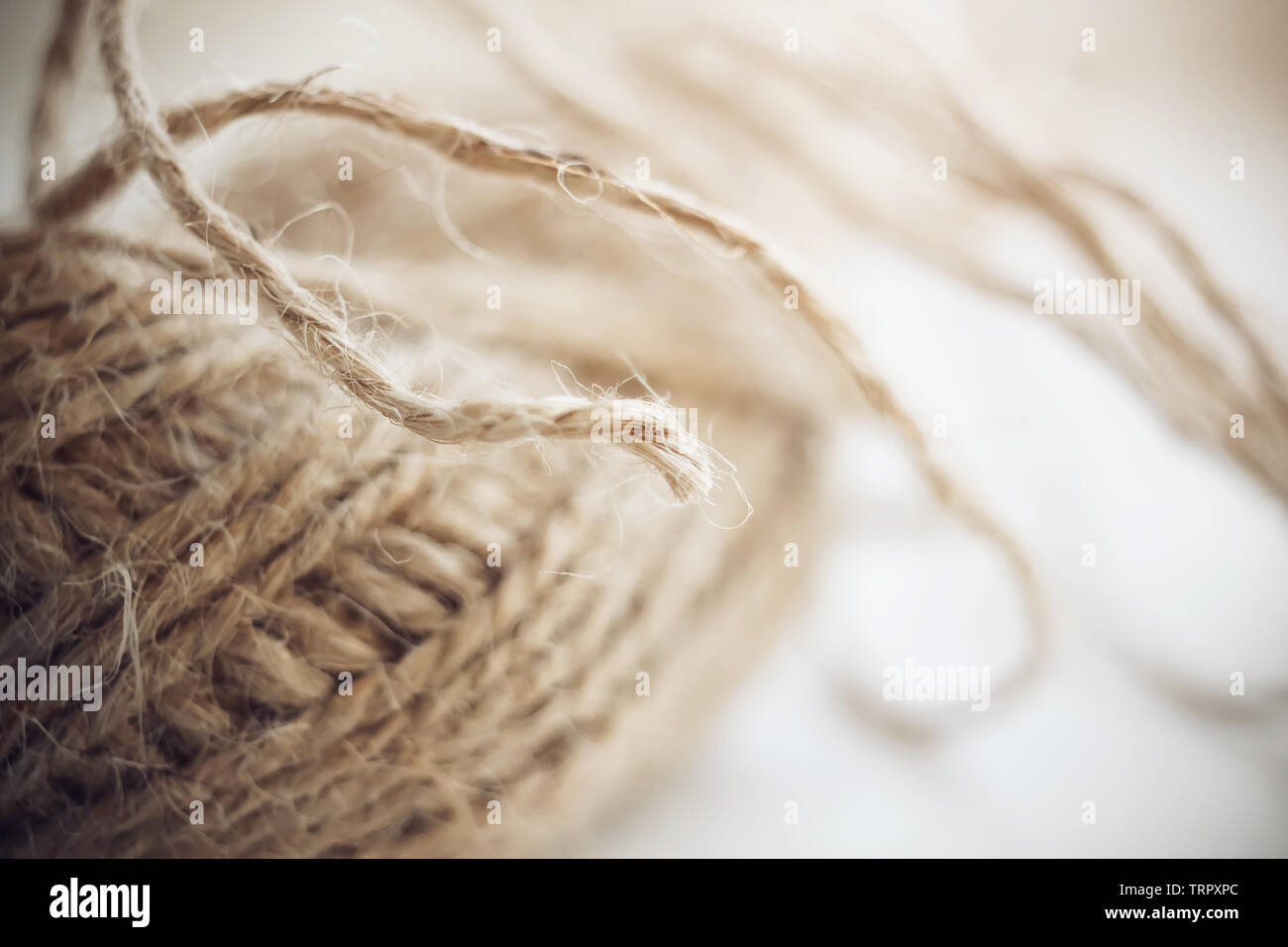 Fluffy the hemp thread is gathered into a ball. The tip of the thread ...