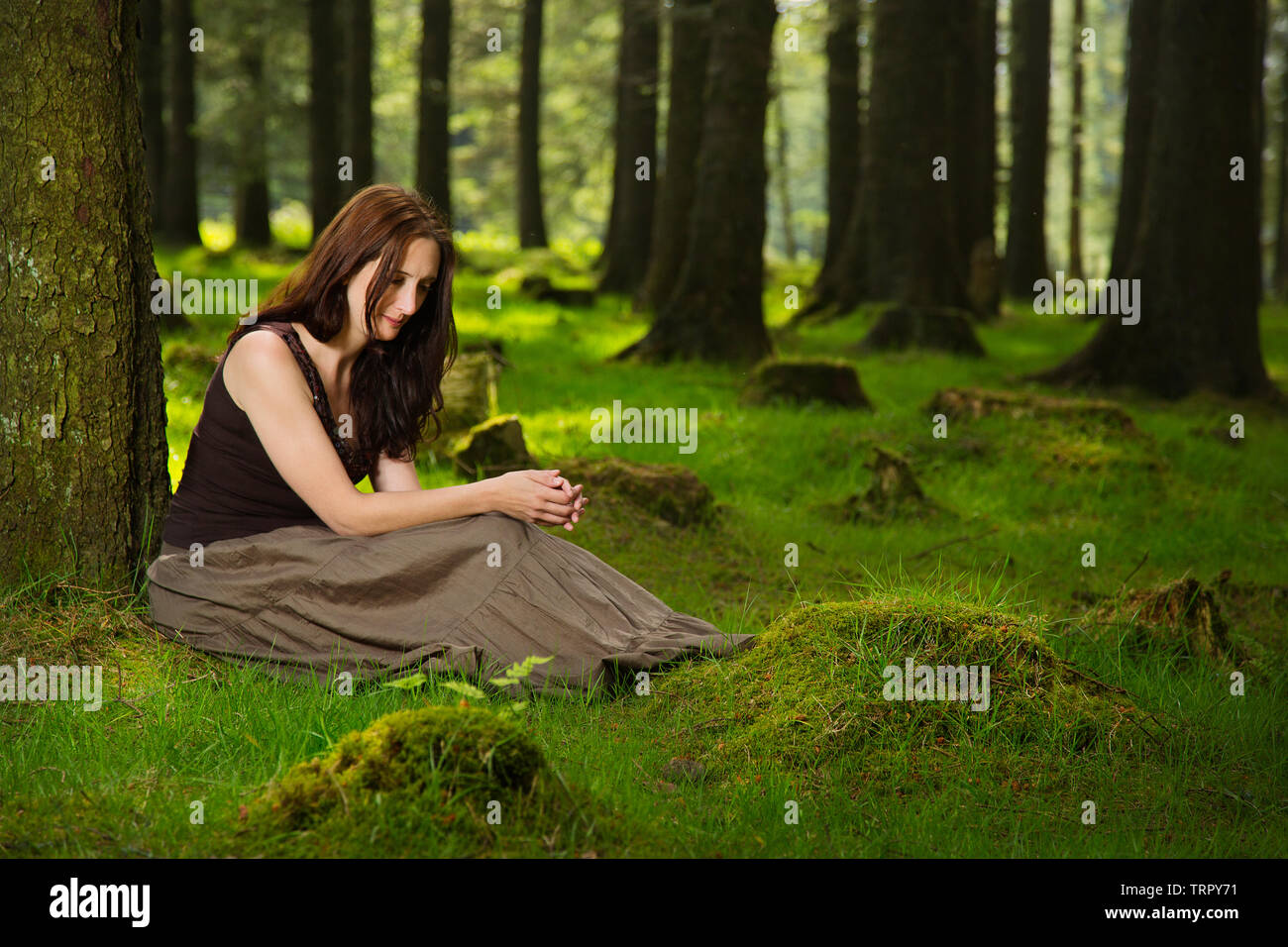 A girl alone in a forest Stock Photo - Alamy