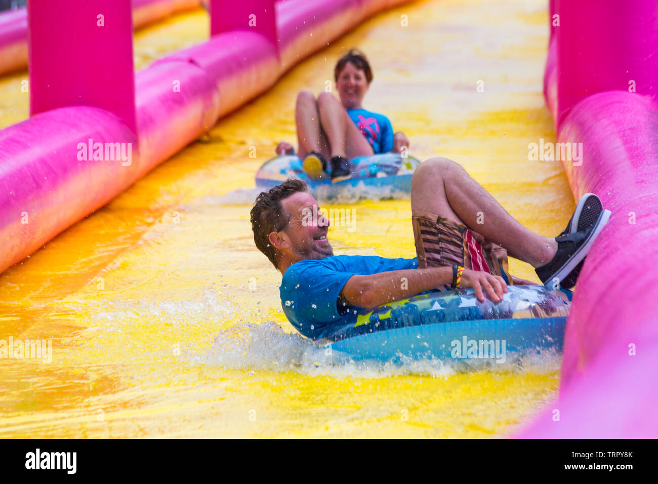 Man and woman sitting on inflatable rings having fun on giant ...