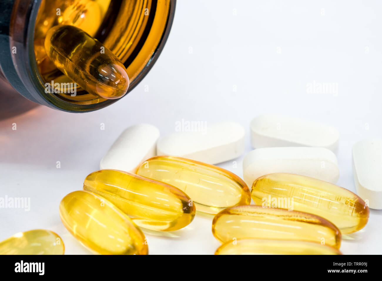 Fish oil capsules with bottle packed on white background Stock Photo ...