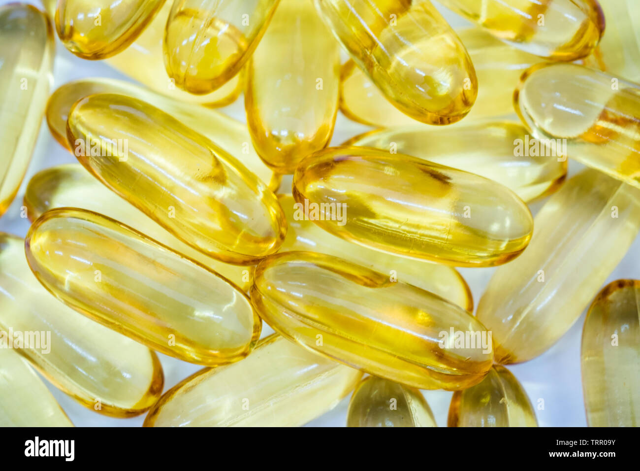 Fish oil capsules close up background Stock Photo - Alamy