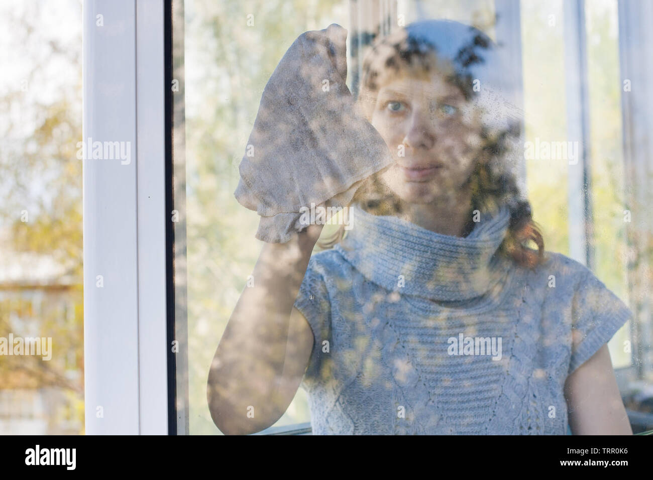 young woman washing window in the room Stock Photo - Alamy