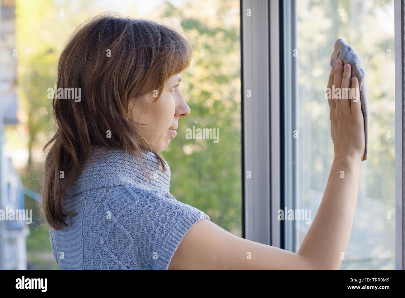 young woman washing window in the room Stock Photo - Alamy