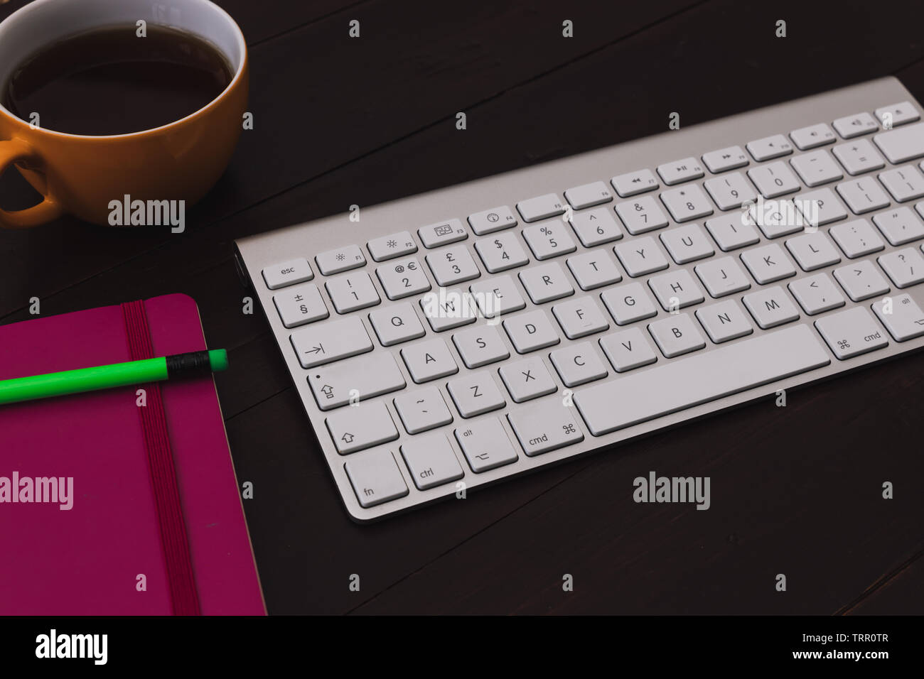 Computer keyboard on wood desk home office Stock Photo - Alamy