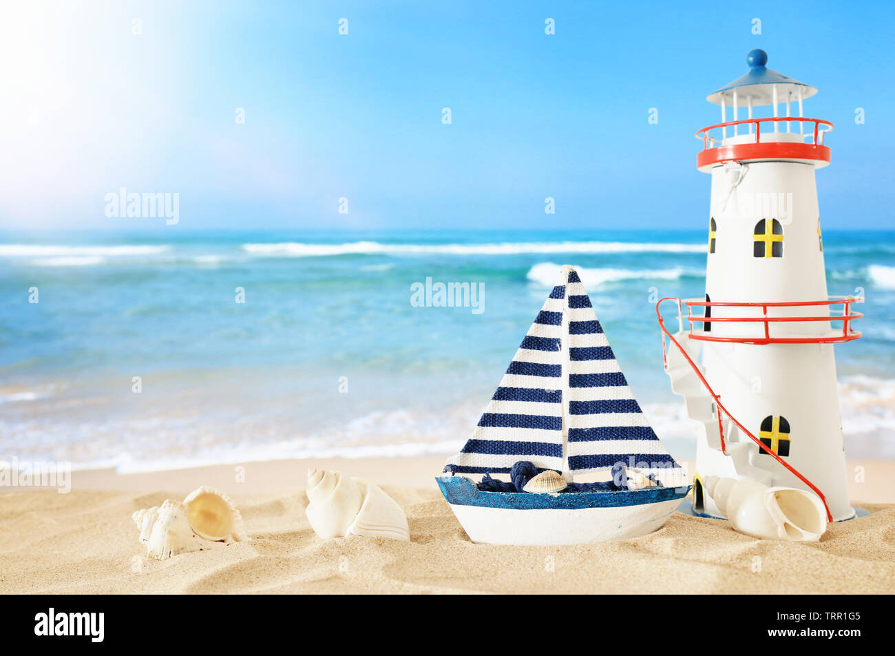 vintage wooden boat and lighthouse over beach sand and sea landscape ...