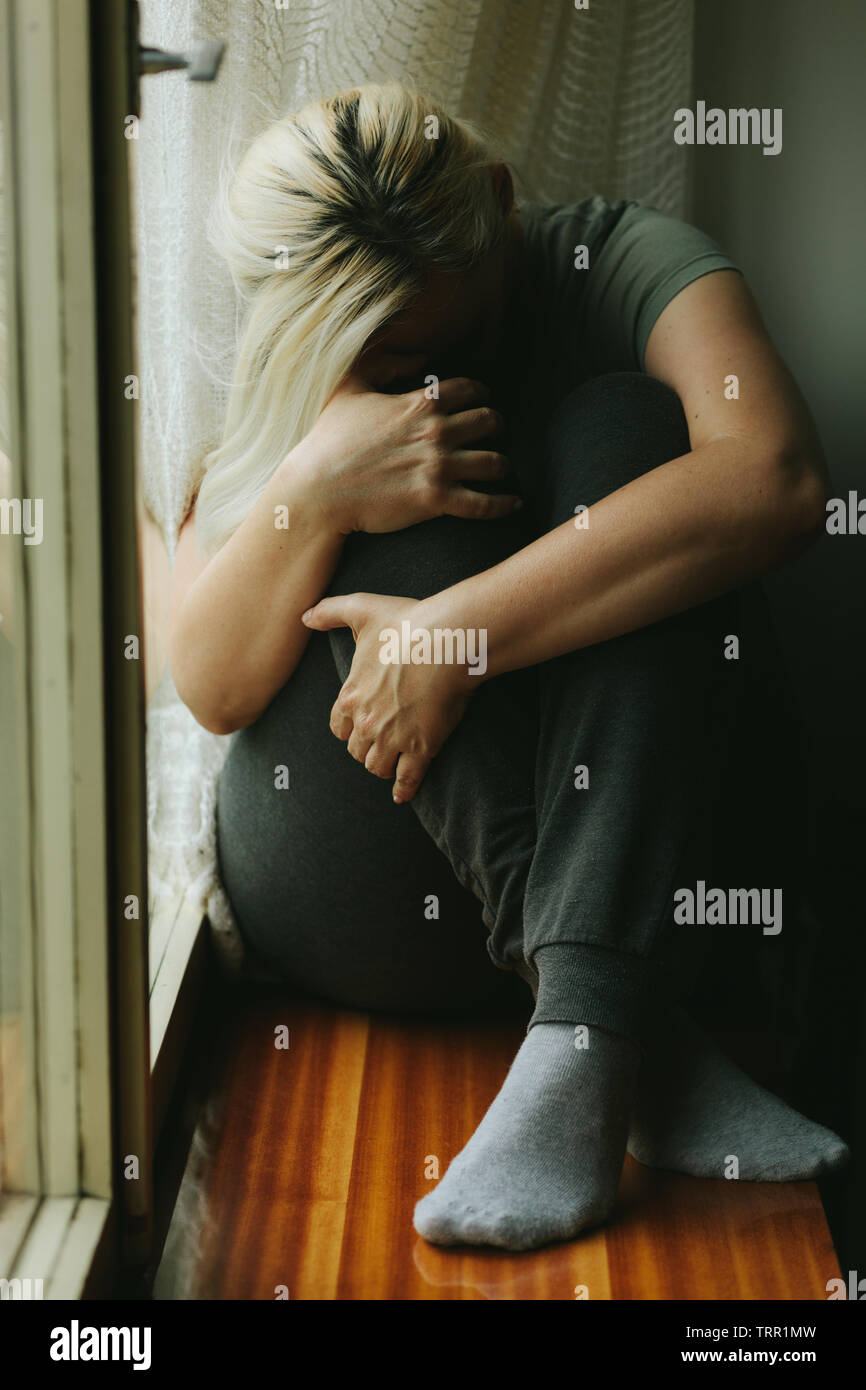 Woman sitting in fetal position hi-res stock photography and images - Alamy