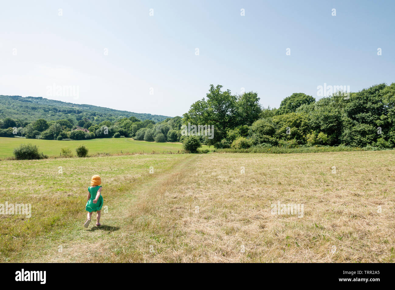 Girl walking across field hi-res stock photography and images - Alamy