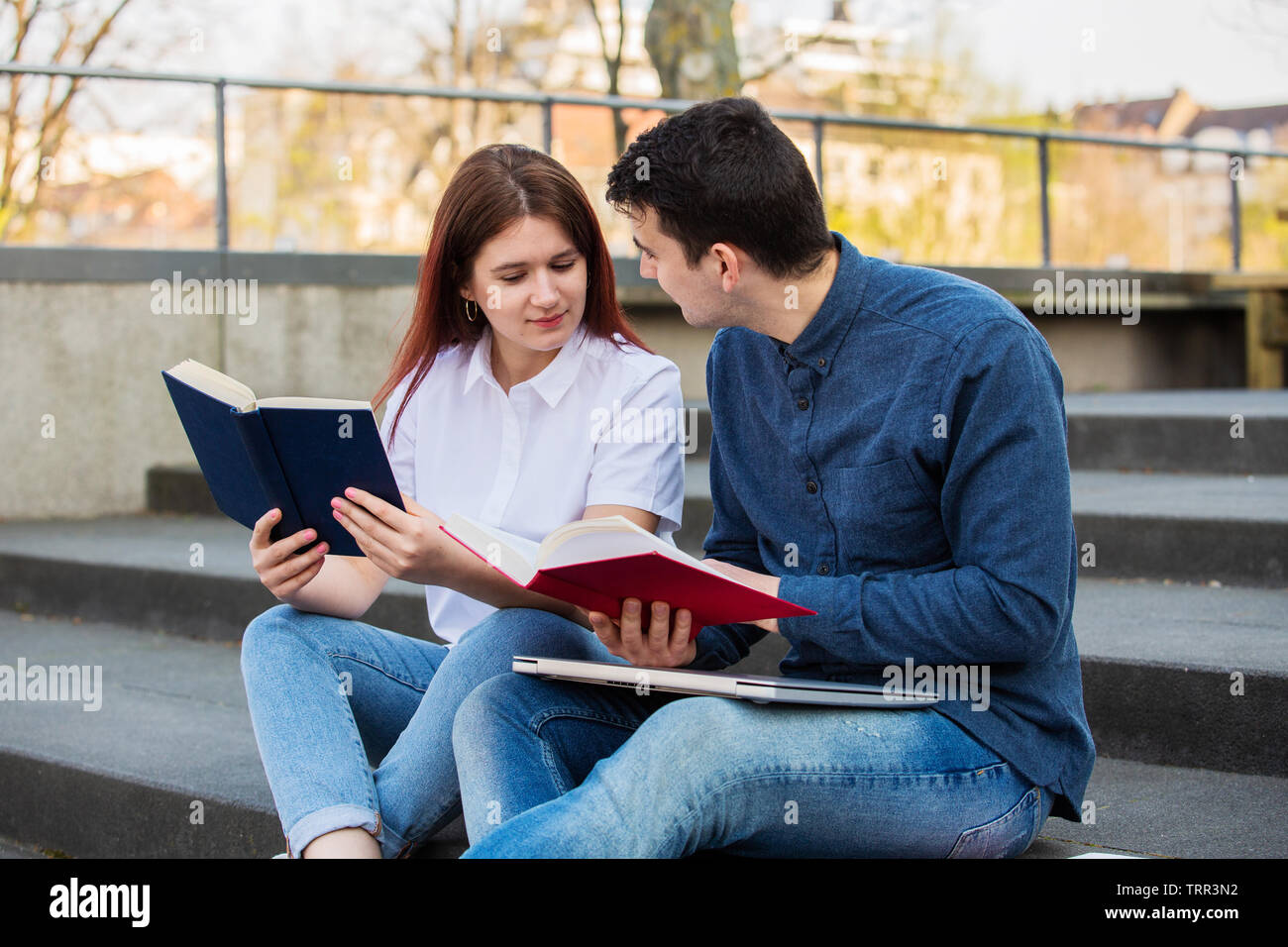 Happy Students using laptop and books learning for the exam together on ...
