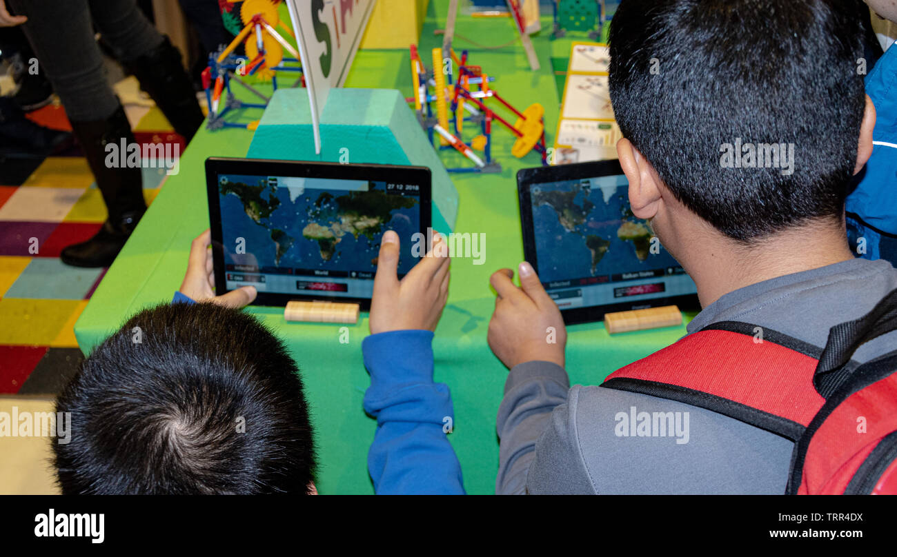 Children playing on the tablets Stock Photo - Alamy